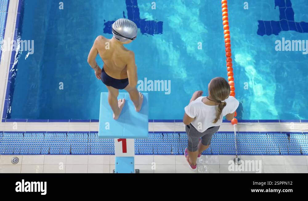 swim athlete training. The coach teaches the boy to dive into the ...