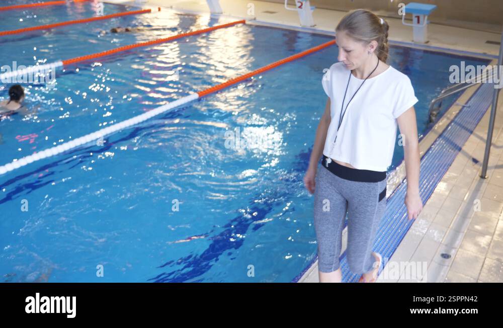 swim athlete training. The coach teaches the boy to dive into the ...