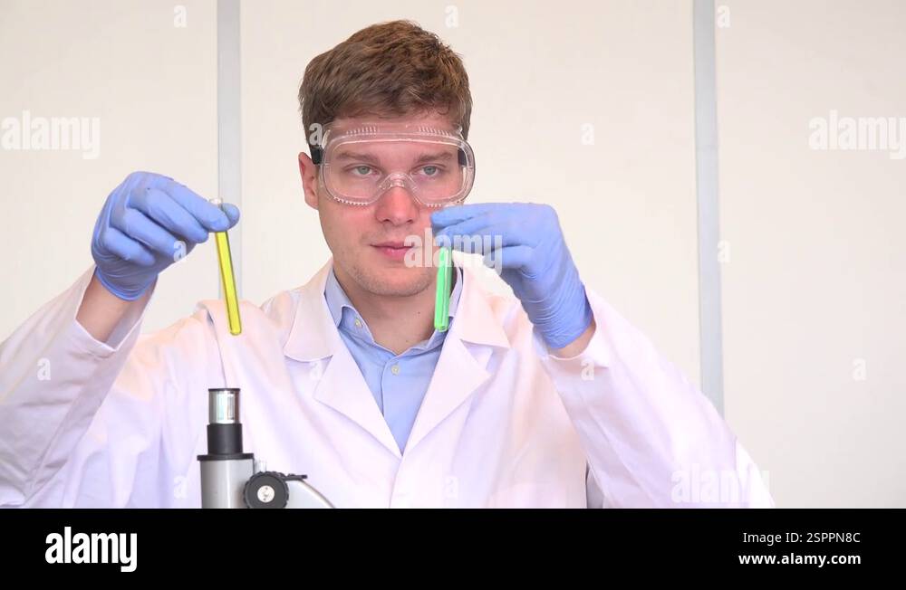Young scientist pharmacist student close up mixing test tubes liquids ...