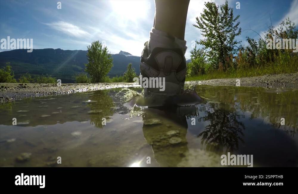 Rear view of fit woman jogging through puddle 4k Stock Video Footage ...