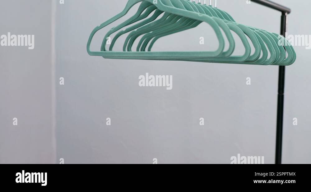 Hangers arranged on clothes rack 4K 4k Stock Video Footage - Alamy