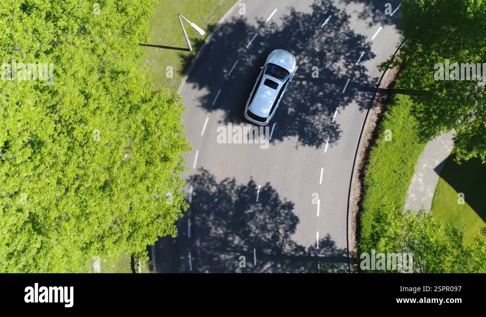 Aerial top-down view following silver grey self driving test car 4k ...