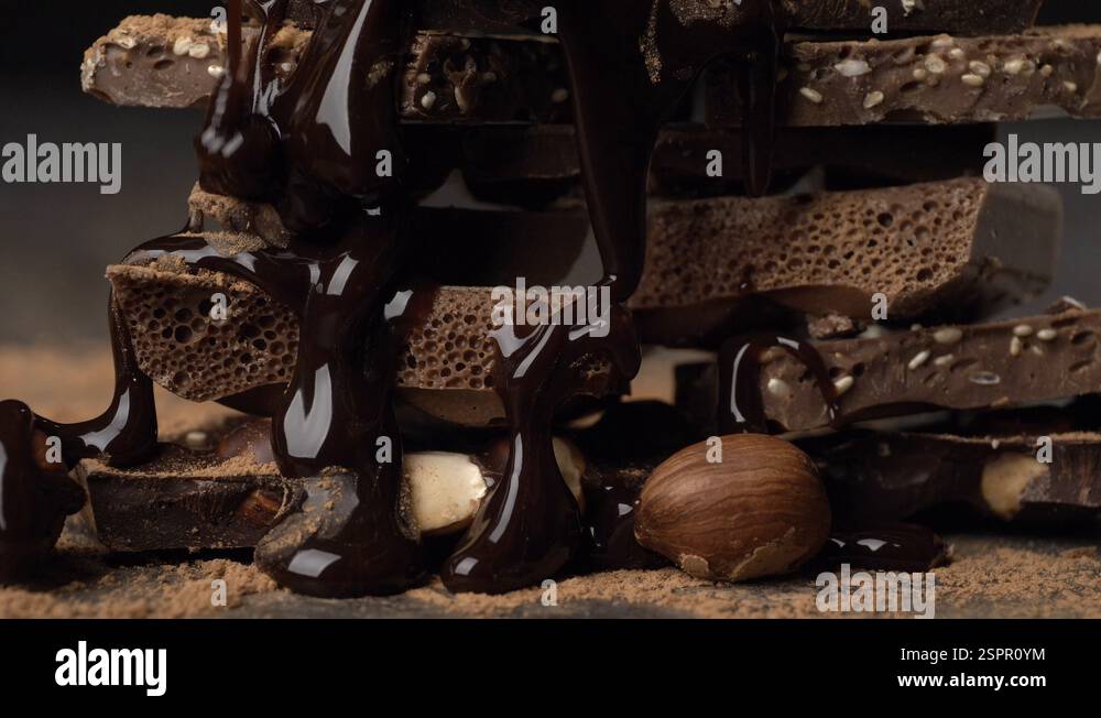 Assorted chocolate and nuts covered with chocolate topping Stock Video ...