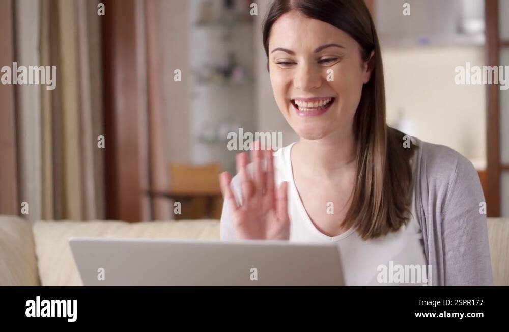 Woman at home with laptop. Using computer talking via messenger app ...