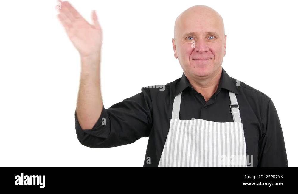 Employee Wearing a Black Shirt and Apron Smile and Salute with Hand ...