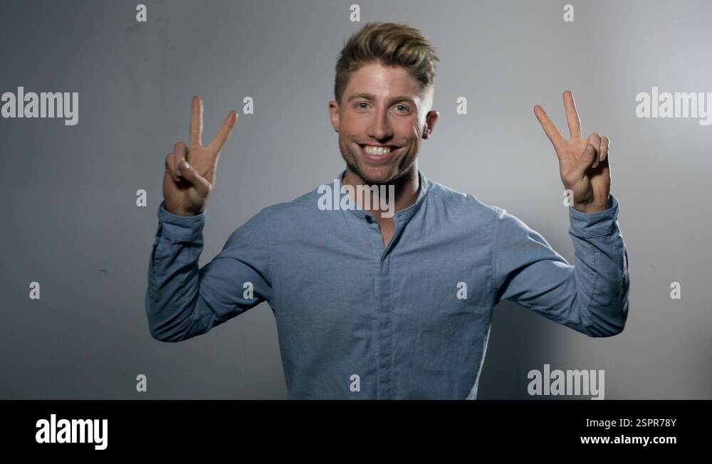 Portrait of a Male Model: Peace Signs and Grin Stock Video Footage - Alamy