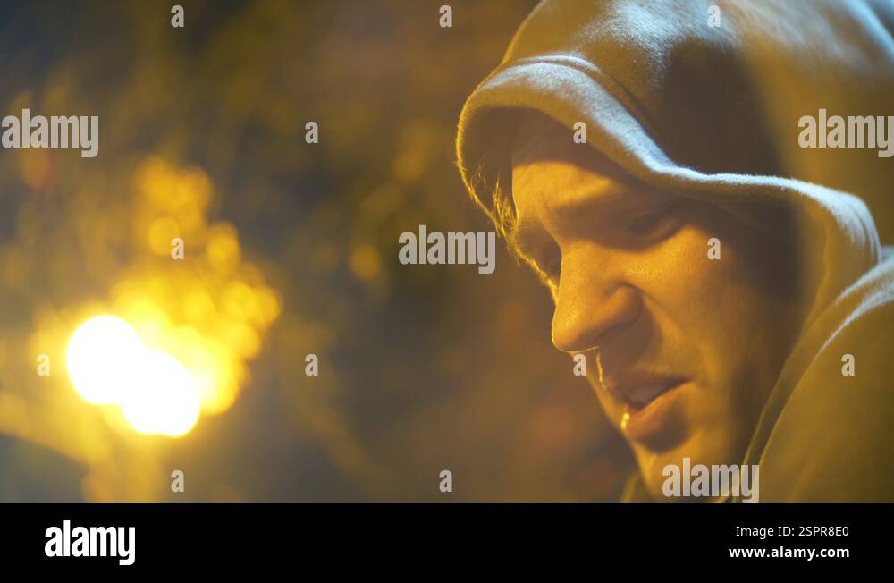 Profile of a sad man with a hood. close-up, background blur, bokeh. 4k ...
