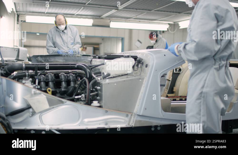 Car manufacturing plant producing electric and standard engine vehicles ...