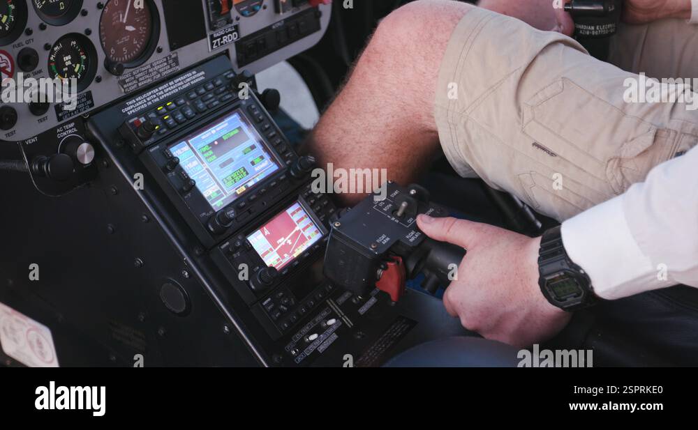 View of instrument panel and helicopter pilot lifting the Collective to ...
