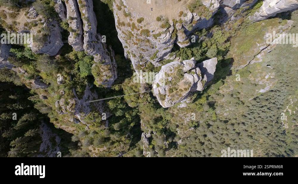 Rope Bridge Across Steep Rock Formations Aerial Overhead Stock Video ...