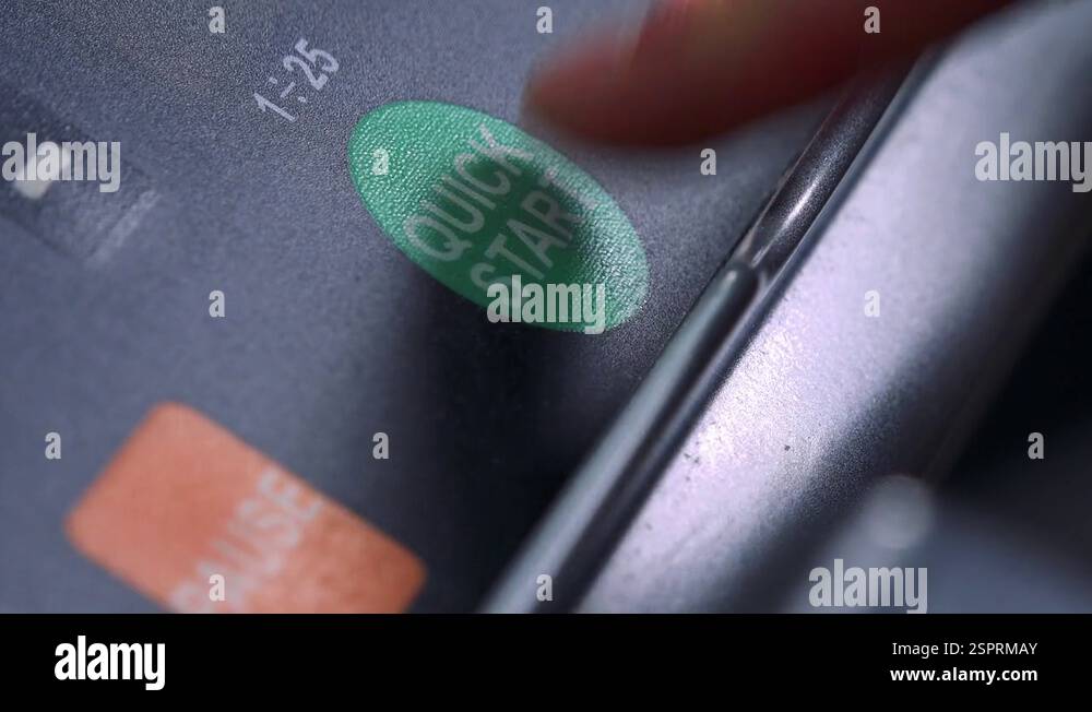 A man presses a "Quick Start" button on a screen of an exercise bike in ...