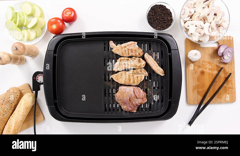 Process of grilling the meat on electronic grill and the steam gets out ...