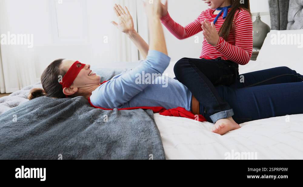 Mother playing clapping game with daughter on bed 4k Stock Video Footage - Alamy