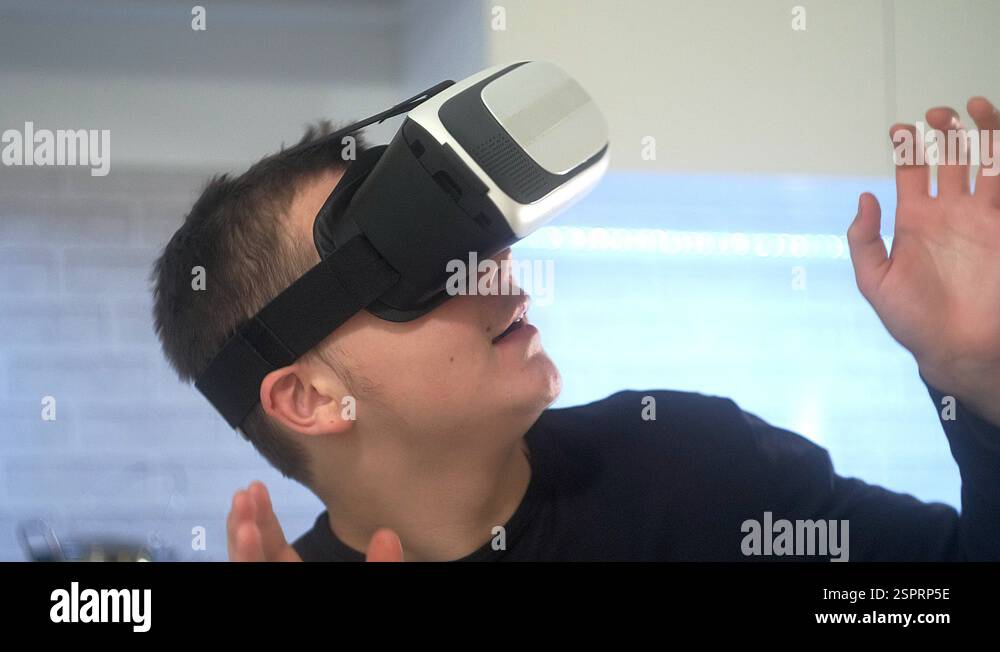 Man Wearing VR Headset at kitchen. Using Gestures with Hands Stock ...
