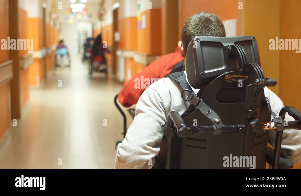 disabled man safely drives wheelchair in corridor institution slow ...