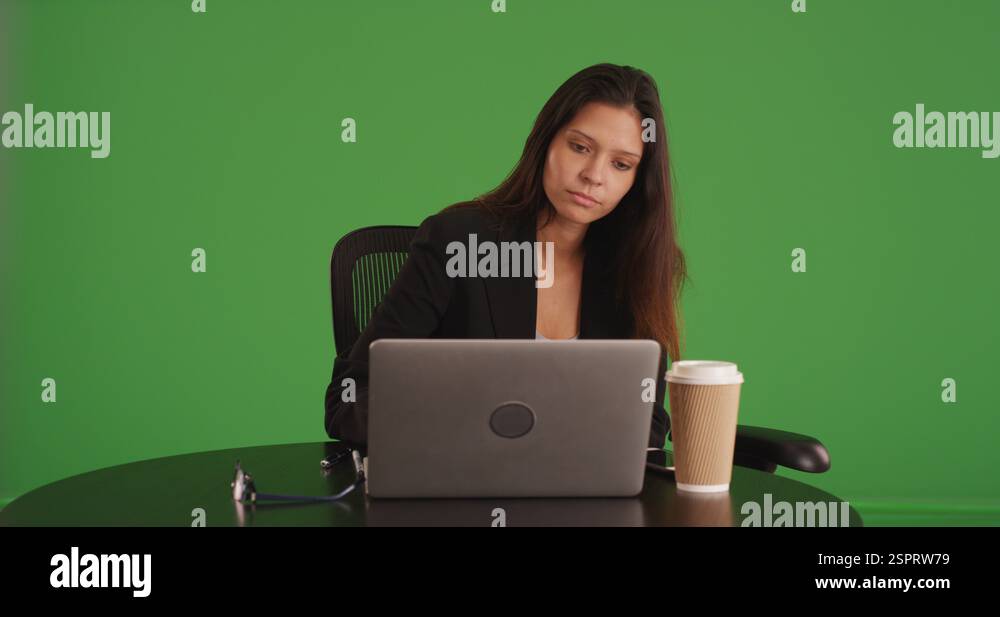 Lovely young professional business woman using tech laptop on green ...