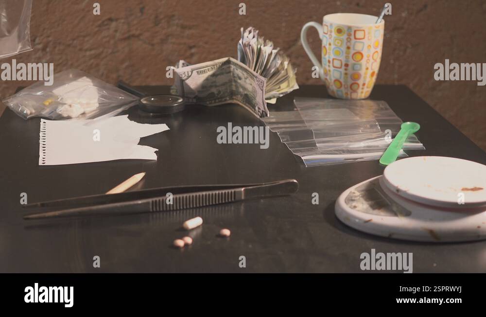 The drug dealer packs drugs - in tablets amphetamine or other - in ...