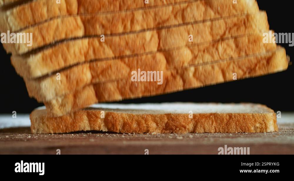 Fresh bread falling in slow motion onto bakers table shot on Phantom ...