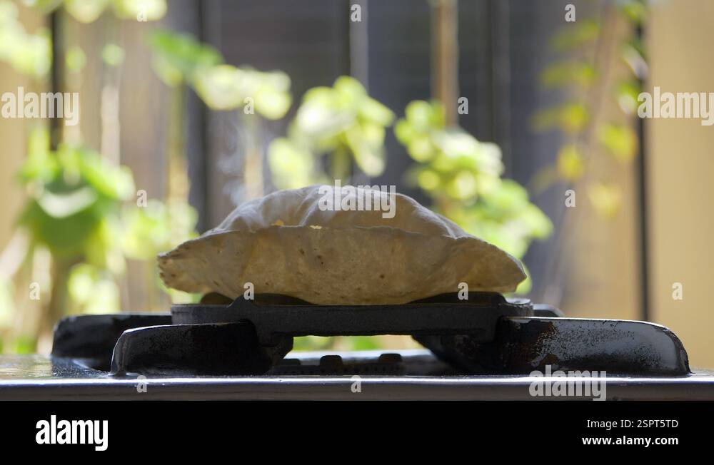 Making of Phulka a kind of Chapati: Indian thin bread made from wheat ...