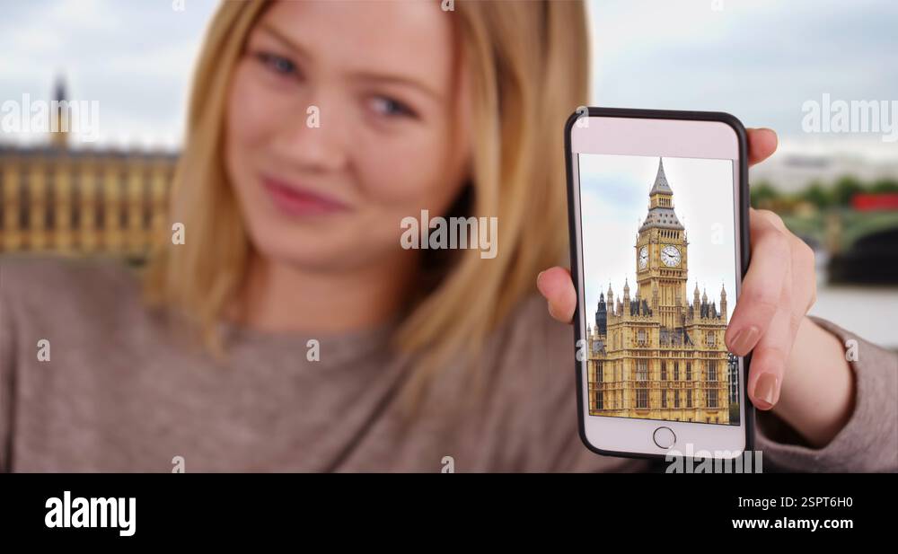 Pretty Caucasian girl showing picture of Big Ben clock tower on smartphone Stock Video Footage ...