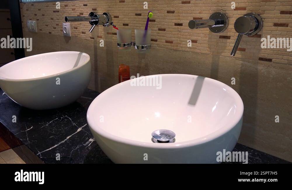 Sinks in a bathroom - closeup from above Stock Video Footage - Alamy