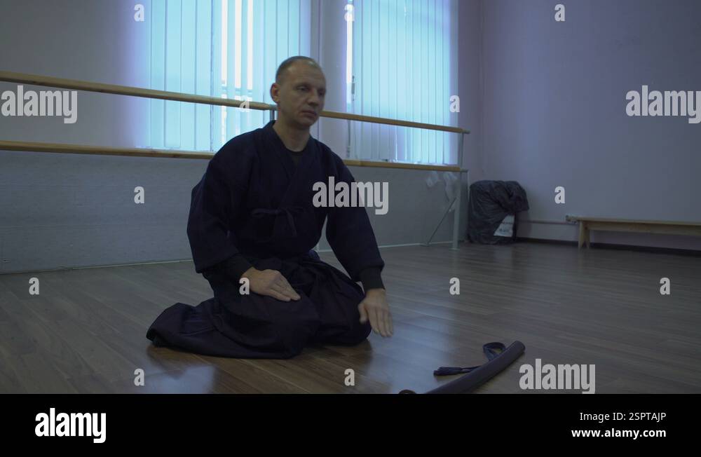 The Samurai Sits on the Floor and Makes a Bow, Takes the Katana's Sword ...
