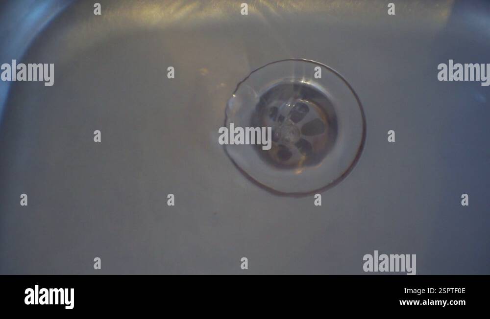 Stainless steel sink plug hole close up with water Stock Video Footage ...