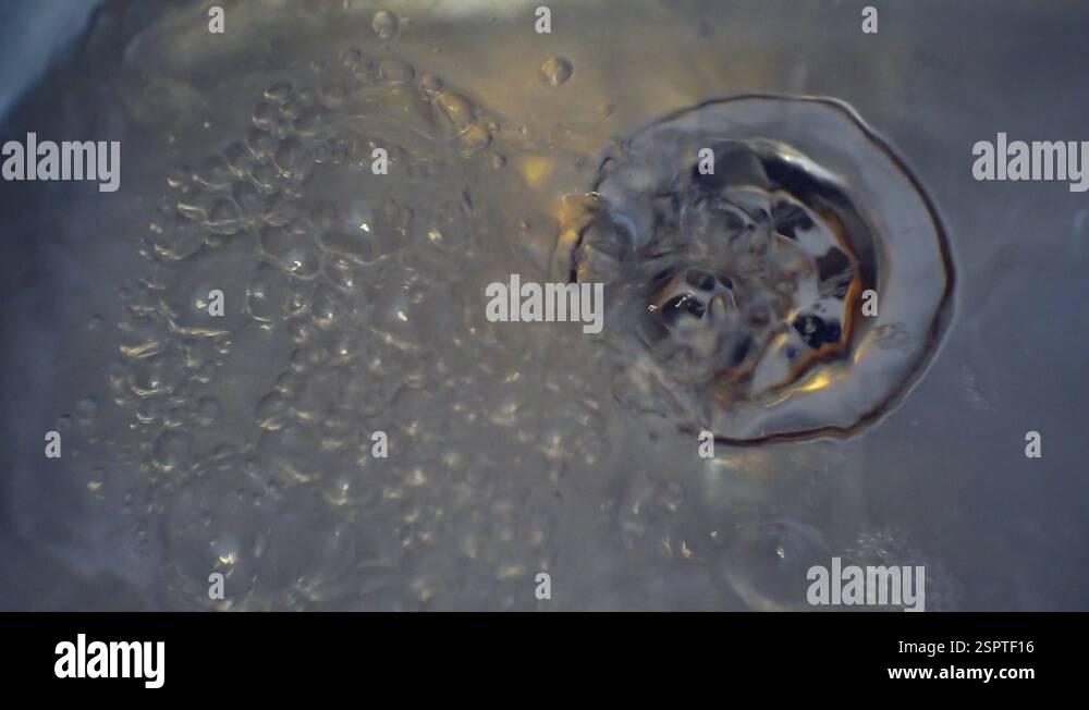 Stainless steel sink plug hole close up with water Stock Video Footage ...