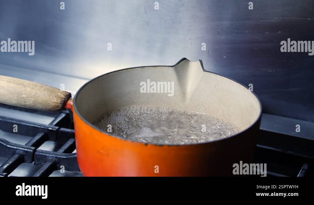 Slow motion Old vintage pan boiling water on Kitchen hob gas burner ...