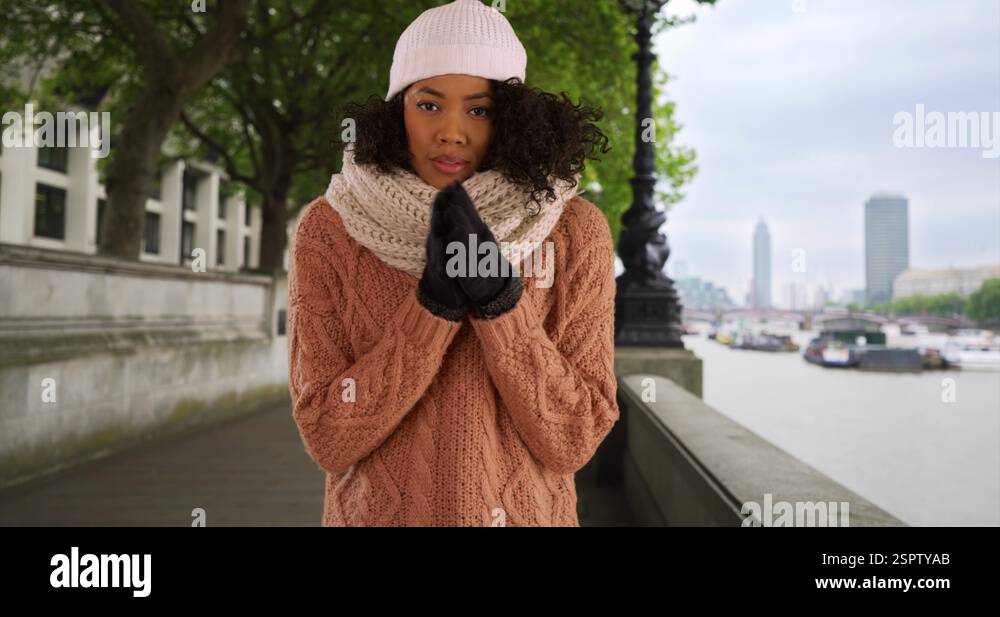 Black woman on holiday in London laughs about chilly weather by the ...