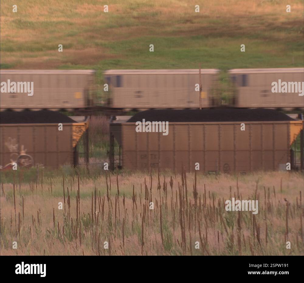 Two very long coal trains pass each other Stock Video Footage - Alamy