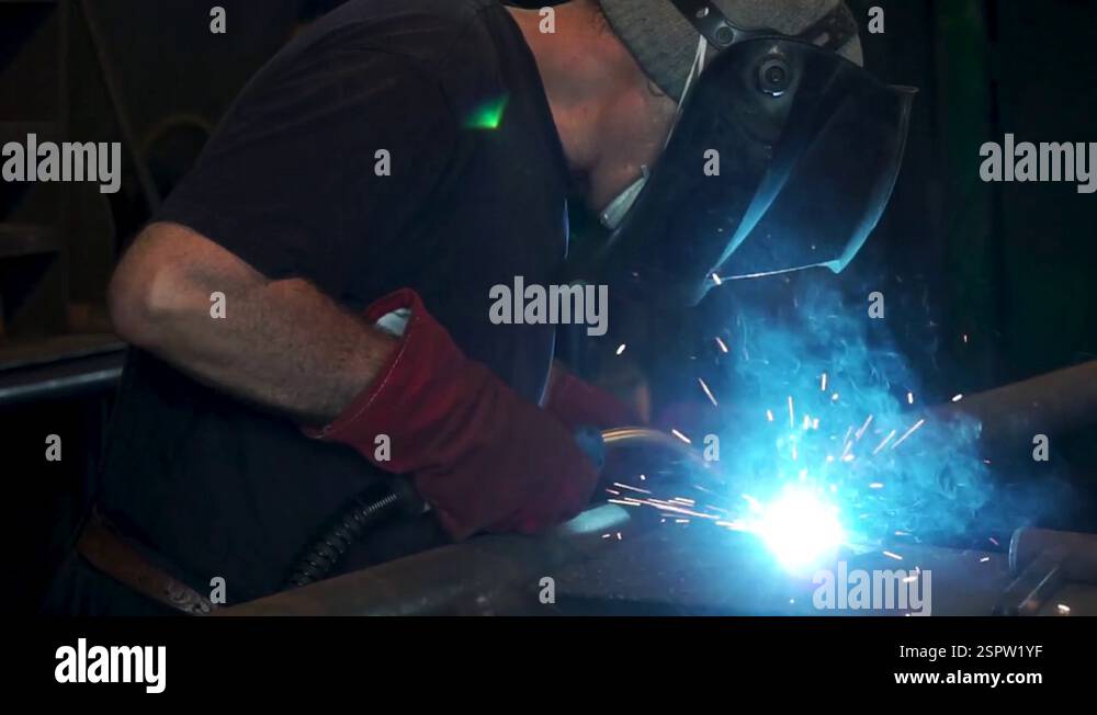 Industrial Worker at the refinery welding close up. Metal sawing close ...