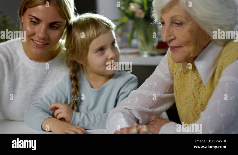 Playful Little Girl Using Laptop with Help of Mom and Grandma Stock ...