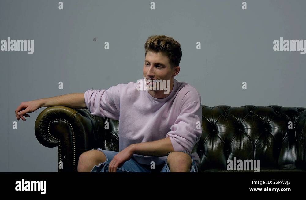 Happy Male Model on Studio Sofa Showing Facial Expressions Stock Video ...
