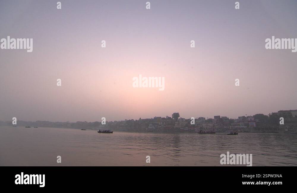 Sunset sky over Ganges River in Varanasi, India, Riverboats crossing ...