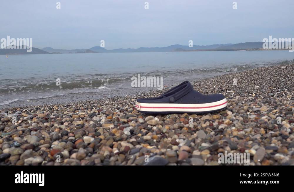 One single lost mule shoe on the beach Stock Video Footage - Alamy
