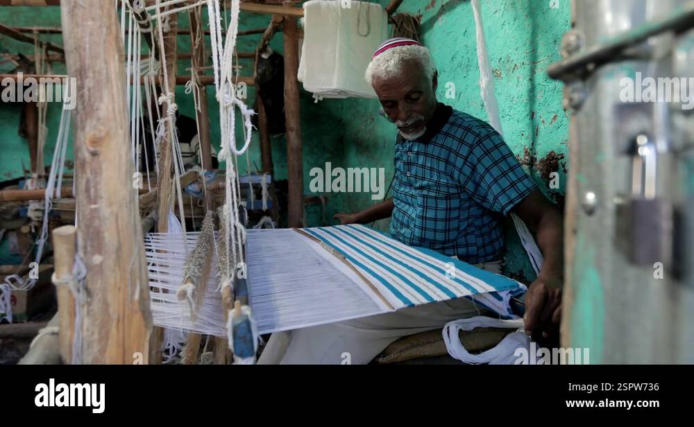 Ethiopia Ethiopian man weaves a carpet made of cotton fabric weaving ...