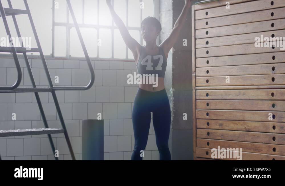 young fit and tone up woman doing heating before a fitness workout in ...