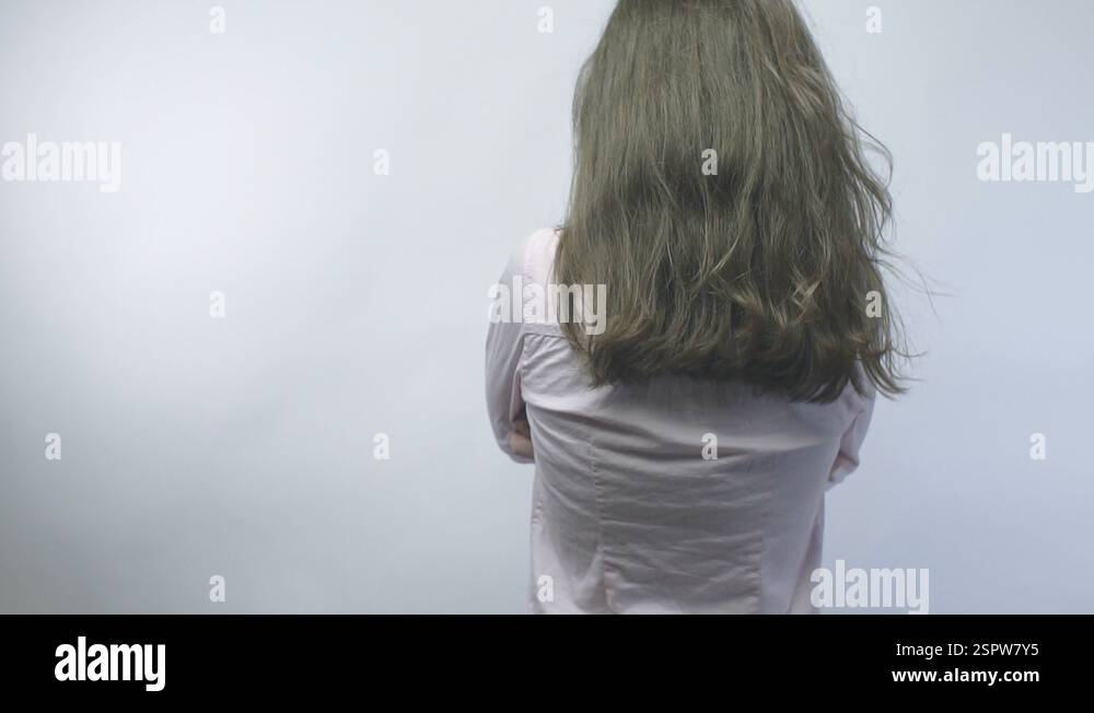 The girl stands with her back and turns angry and offended looks into ...