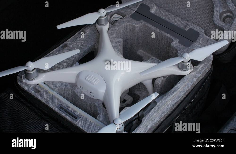 a young person takes a white drone out of the black suitcase Stock ...