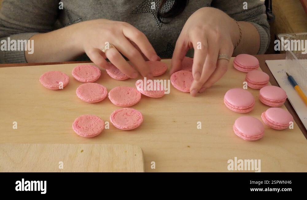 Chef make of a macaron between which is a cream. Cook makes beautiful ...