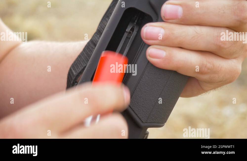 Man Loading a Red Shell into a Pump Action Shotgun in Slow Motion Stock ...
