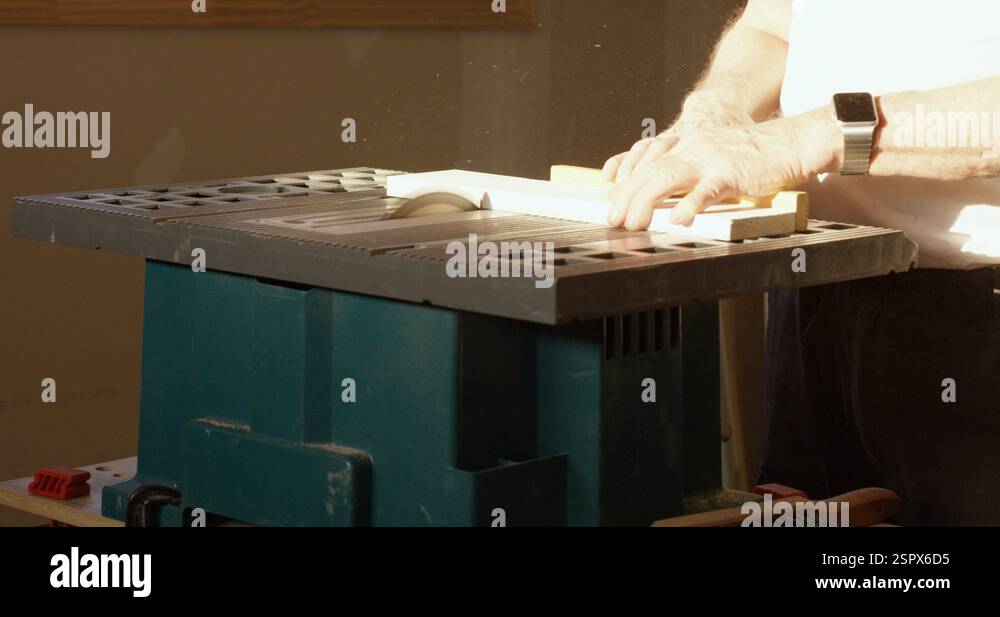 Man using table saw to cut wood in brightly lit workshop Stock Video ...