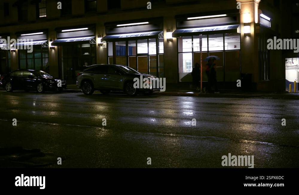 People walk by generic store in the city on a rainy evening Stock Video ...