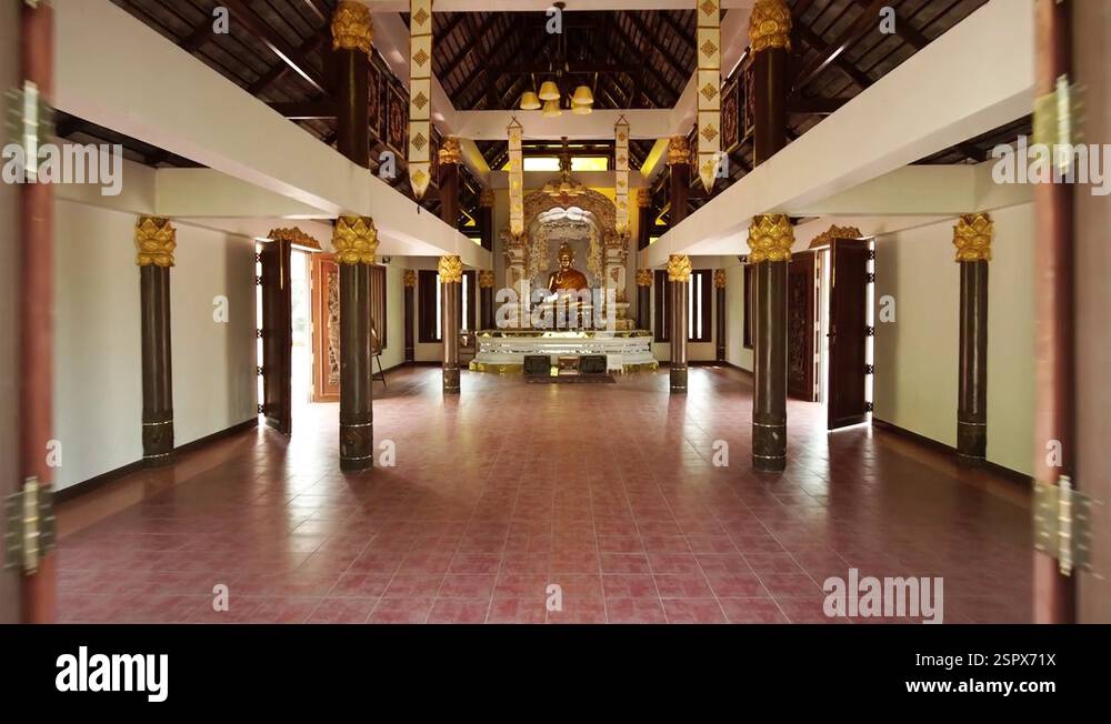 Camera moves inside Thai Buddhist Temple directly to the Buddha statue ...