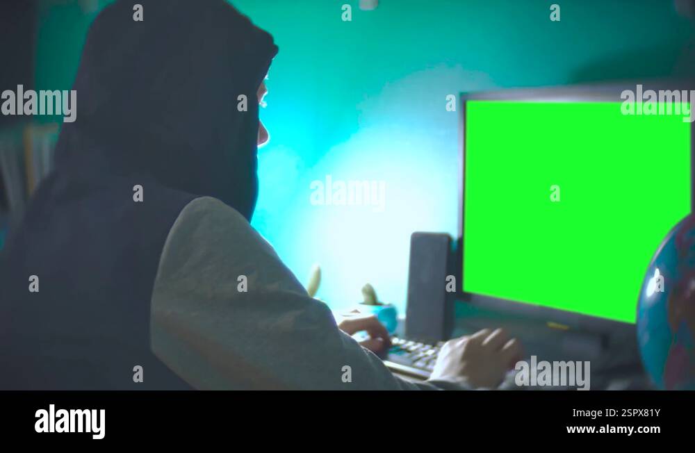 Hacker man programmer in the hood using computer for hack information ...