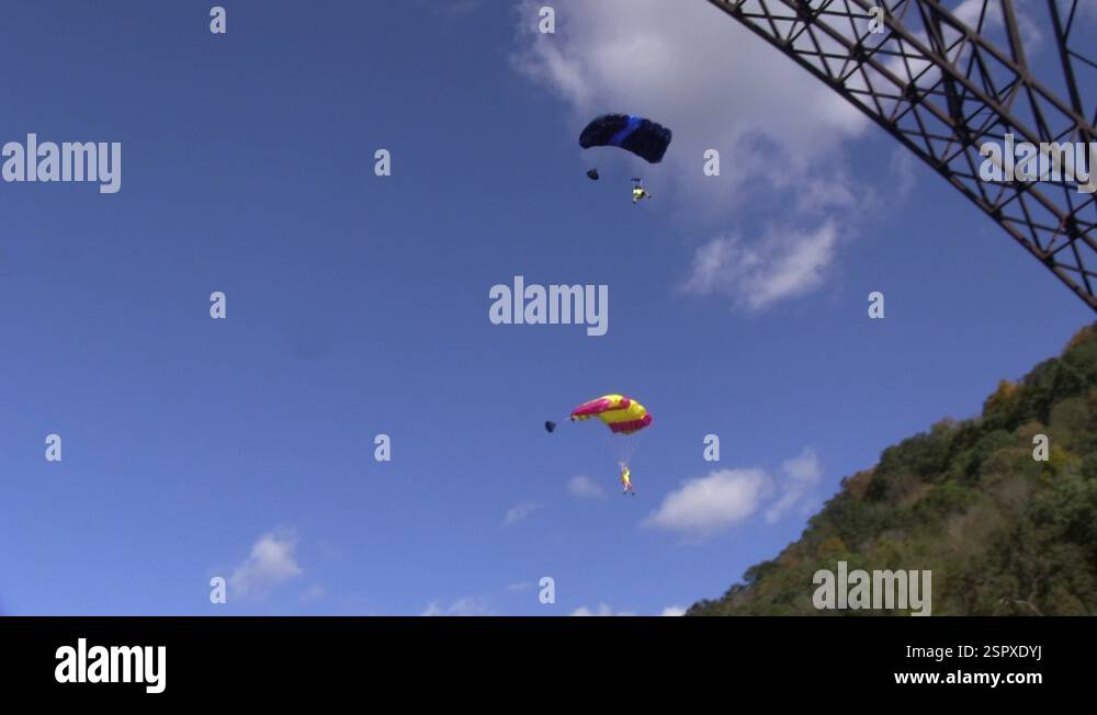 Base jumpers floating through air under the New River Gorge Bridge ...