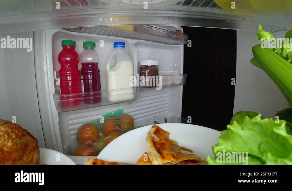 girl teenager opens the refrigerator at night. night hunger. diet ...