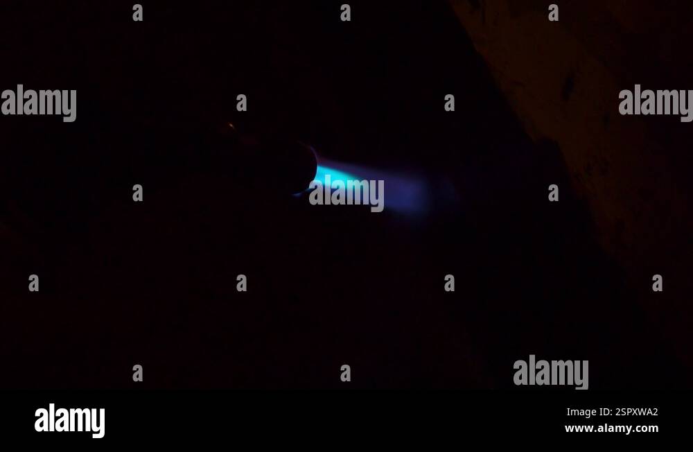 operating industrial gas burner, which burns with a blue flame. close ...