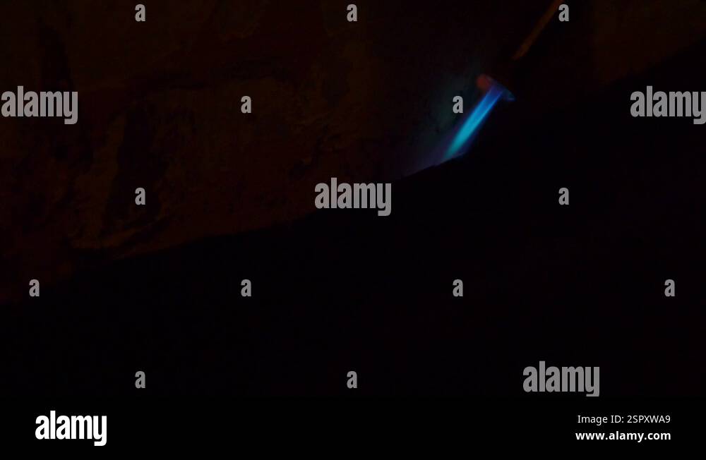 operating industrial gas burner, which burns with a blue flame. close ...